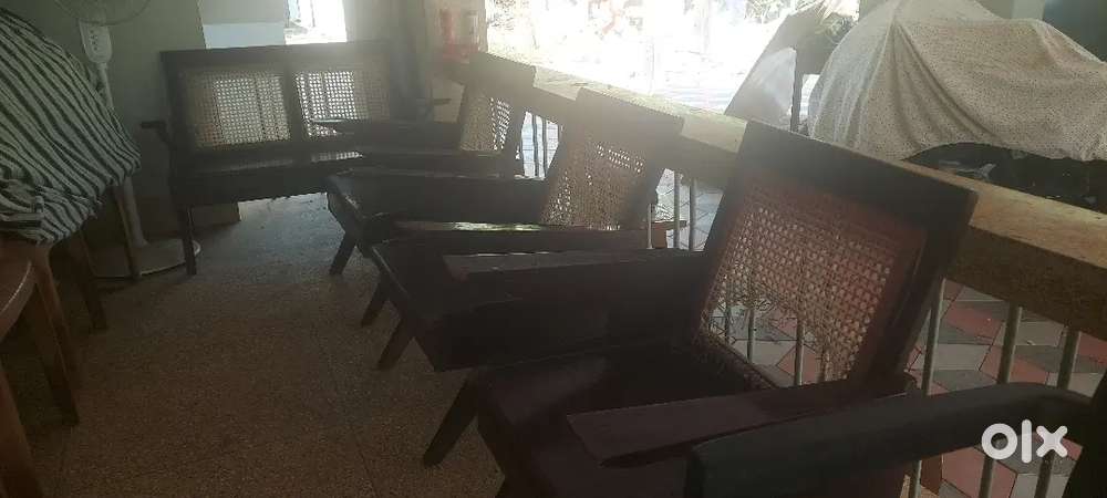 Old Sofa set with its seat made of wood and backrest woven plastic net ...